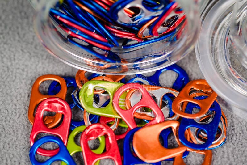 Top Down Close Up View of a Jar of Multi Colored Can Pull Tabs Laying ...