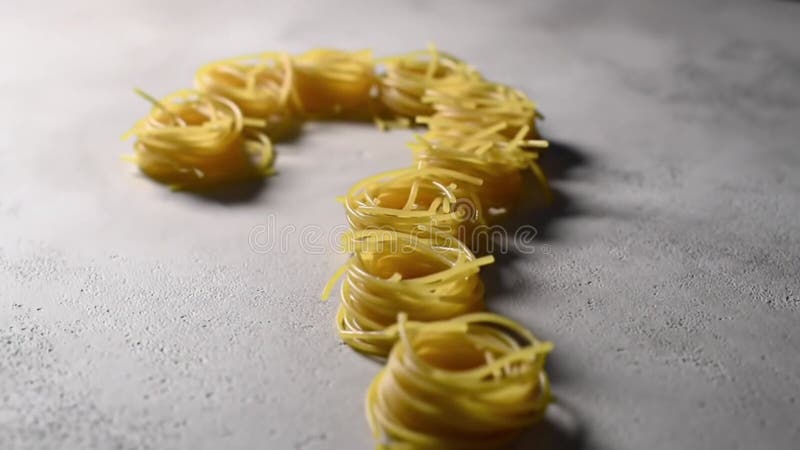 Yellow Spaghetti Arranged As Question Mark on Textured Neutral ...