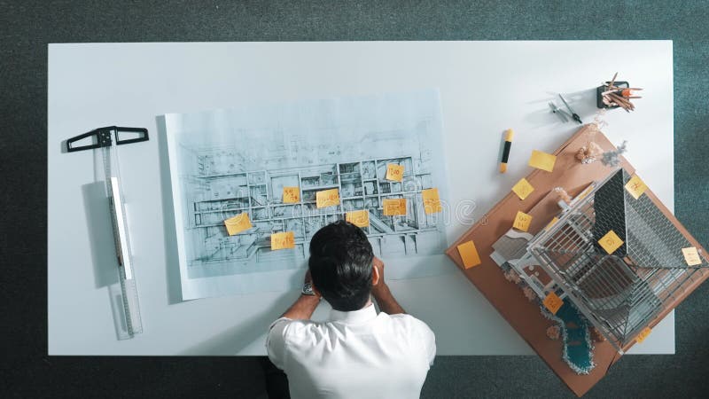 Top View of Engineer Writing Idea on Note and Stick on Blueprint ...