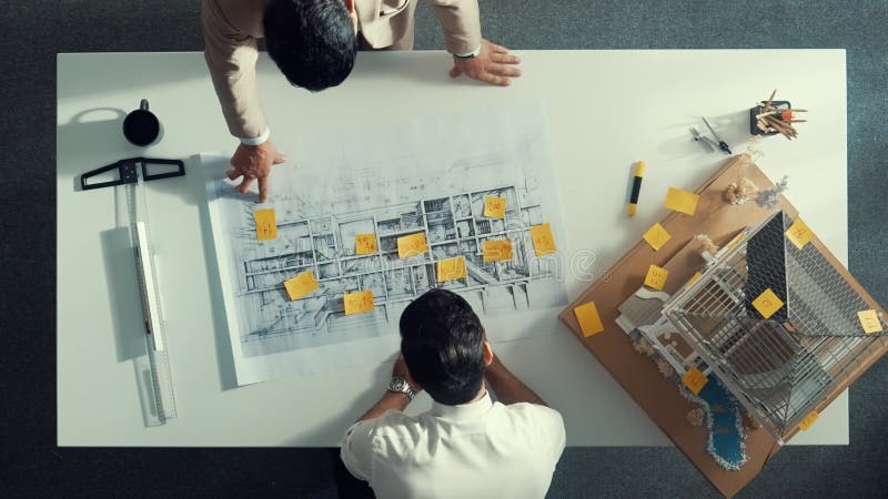 Top View of Engineer Writing Idea on Note and Stick on Blueprint ...