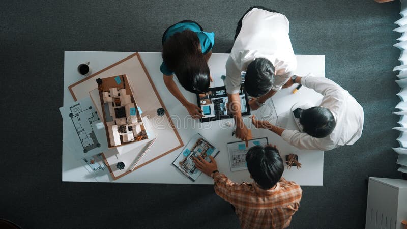Top Down View of Architect Team Discussing and Pointing at Tablet ...
