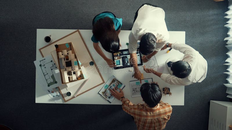 Top Down View of Architect Team Discussing and Pointing at Tablet ...