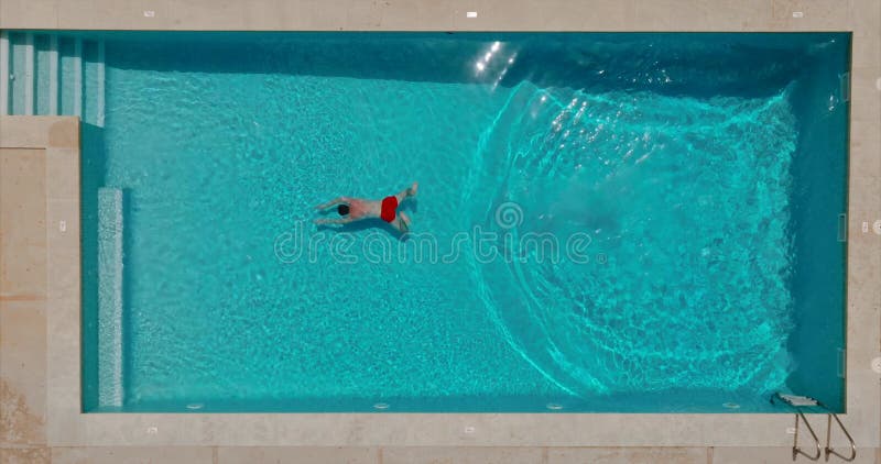 Aerial View As a Man Dives into the Pool and Swims. Stock Video - Video ...