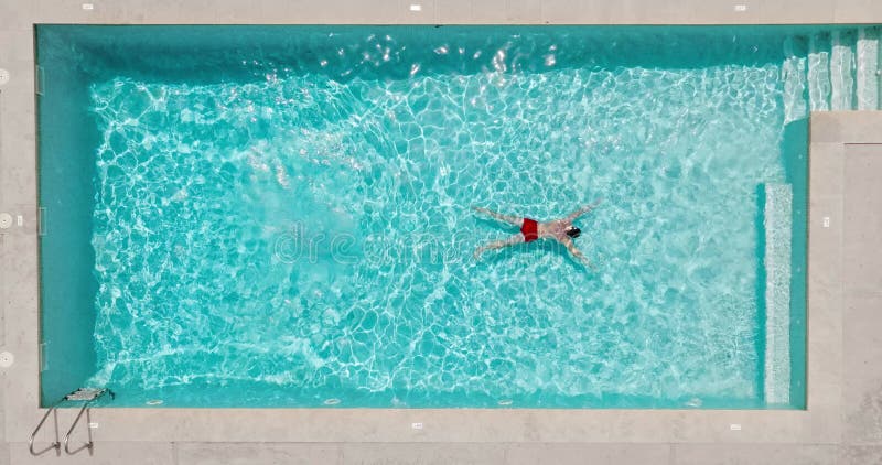 Aerial View As a Man Dives into the Pool and Swims. Stock Footage ...