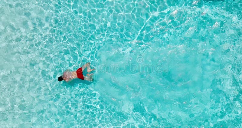 Aerial View As a Man Dives into the Pool and Swims. Stock Video - Video ...