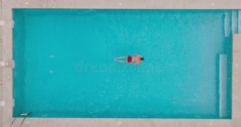 Aerial View As a Man Dives into the Pool and Swims. Slow Motion Stock ...