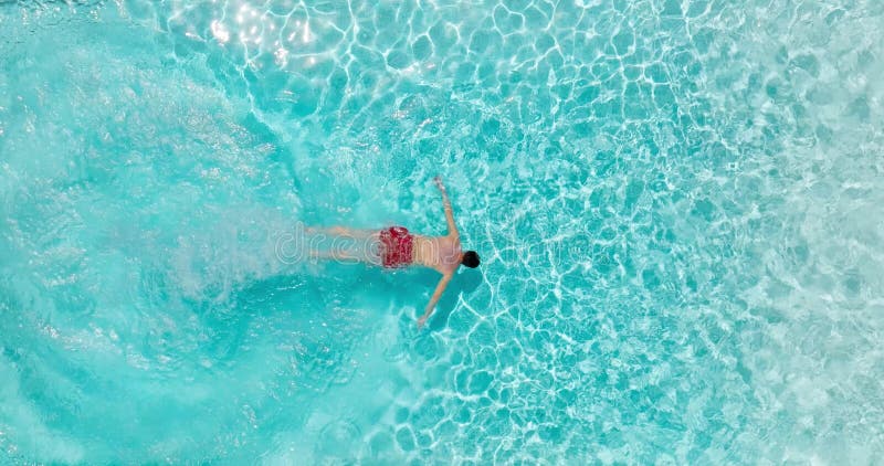 Aerial View As a Man Dives into the Pool and Swims. Slow Motion Stock ...