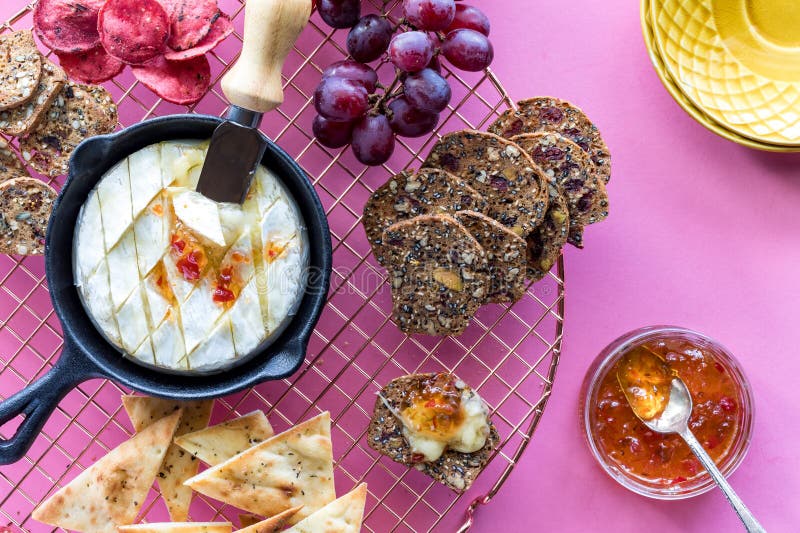 Top Down View of Baked Brie Served with Assorted Crackers and Red ...