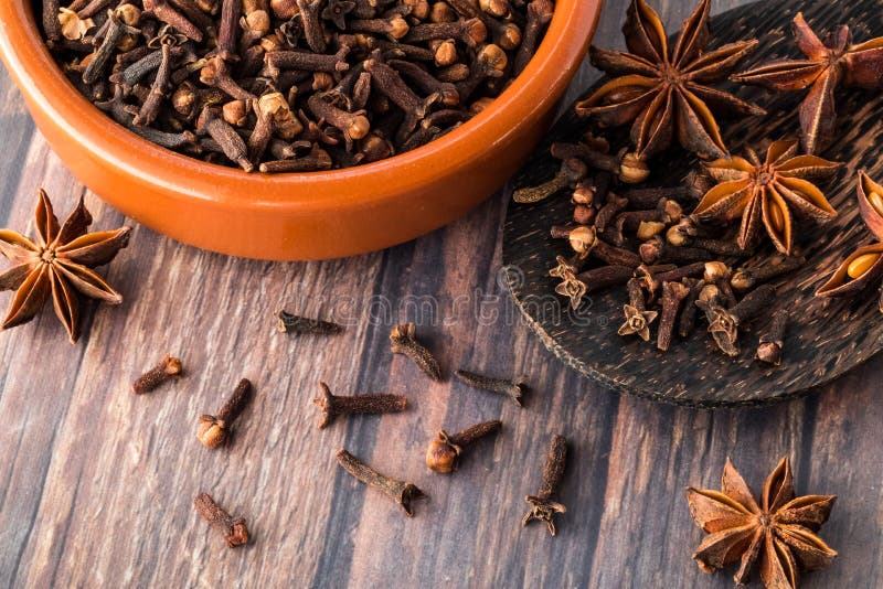 Top Down View of a Bowl of Cloves Surrounded by Cloves and Star Anise ...