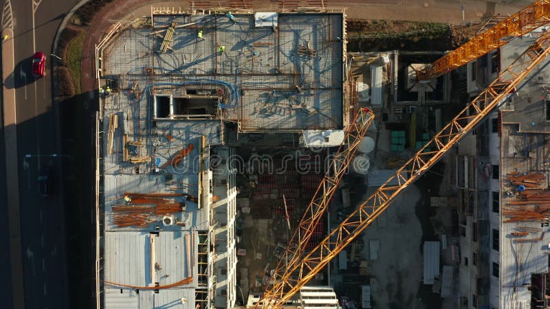 Top Down View of Building Construction with Tower Cranes and Workers ...