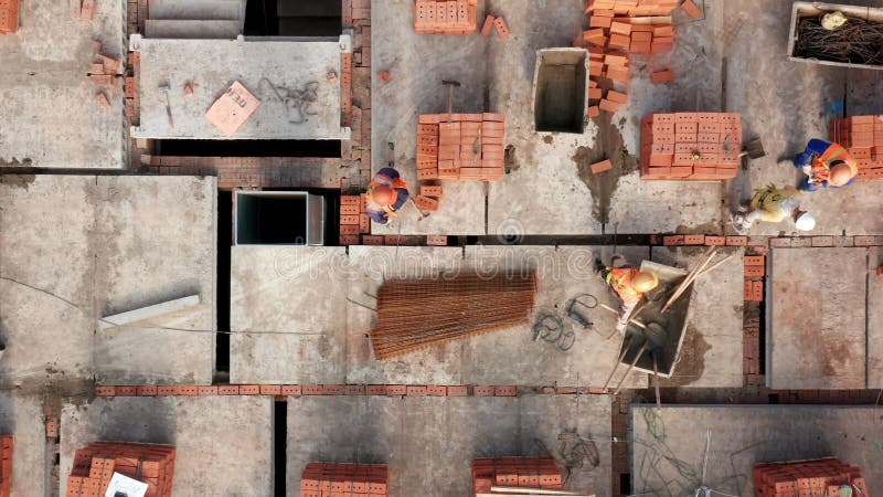 Top Down View at Contractors in Safety Hats with Bricks and Cement on ...