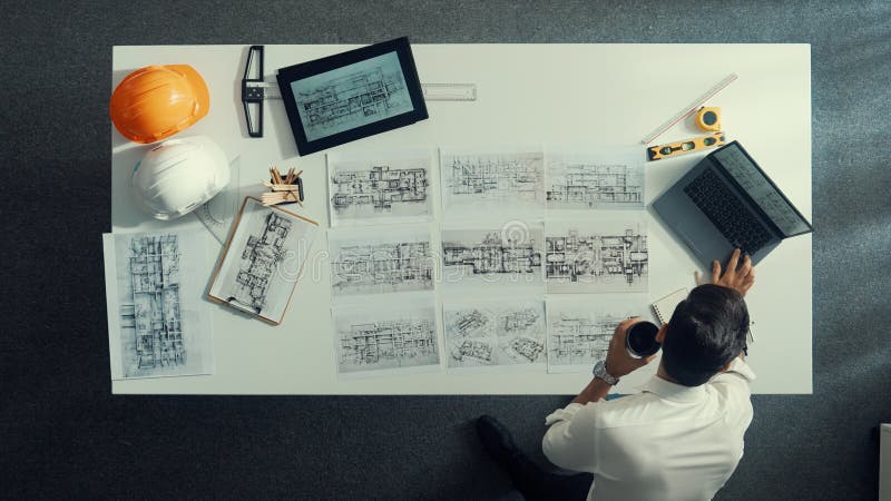 Top View of Engineer Looking at Tablet while Looking at Laptop. Alimentation. Stock Image ...