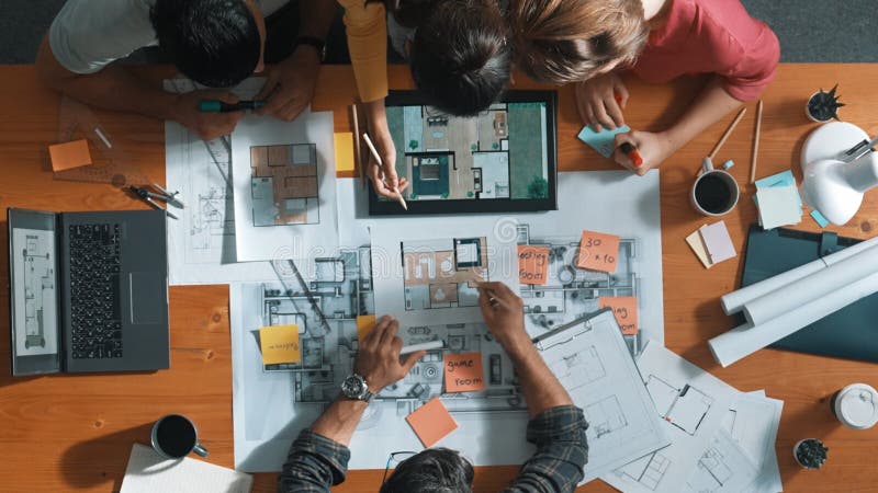 Top Down View of Civil Engineer Planning and Writing at Blueprint ...