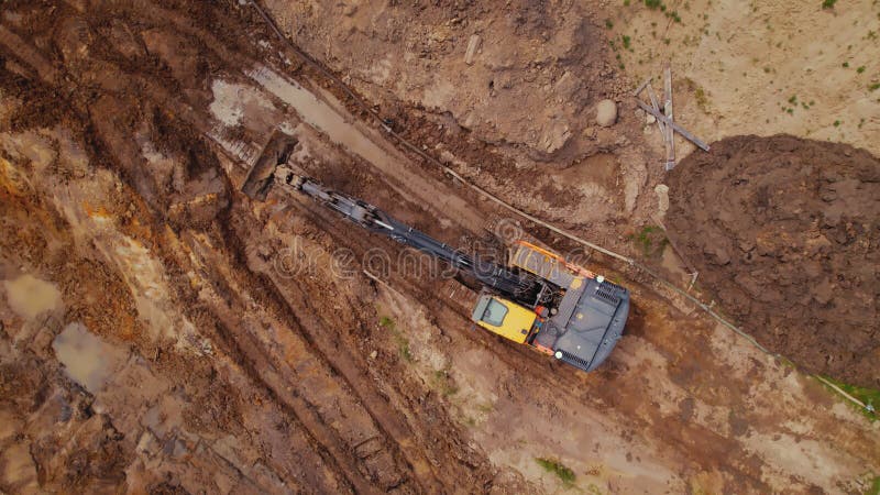 Top Down View of an Excavator Working on the Construction Site on Red ...