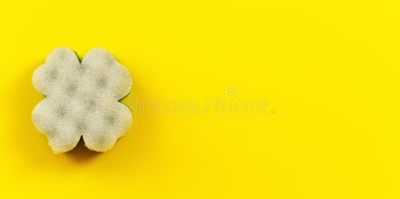 Top Down View - Four Leaf Clover Shaped Bathroom Sponge on Yellow Board ...