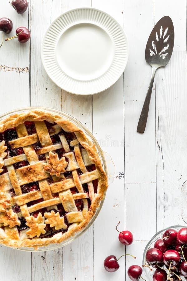 Top Down View of a Freshly Baked Lattice Cherry Pie with Plates for ...