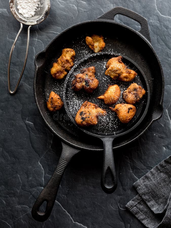 Top Down View of Fritters with Powdered Sugar in Cast Iron Fry Pans ...
