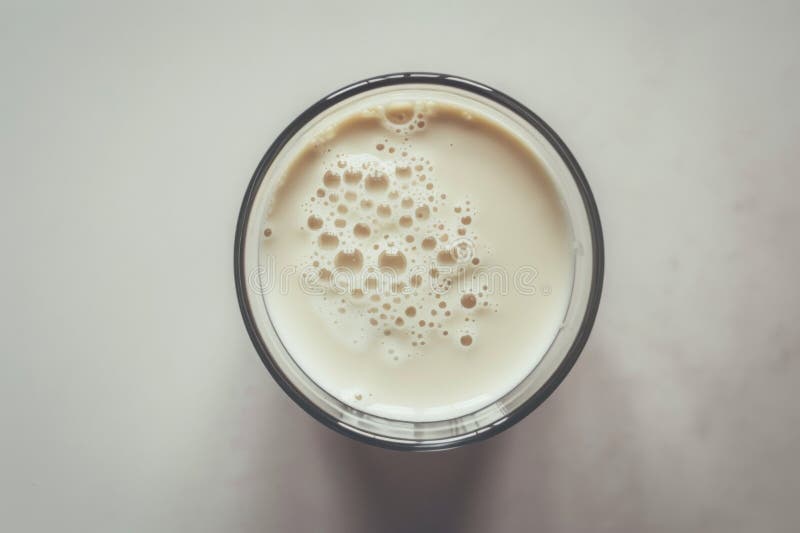 A Top-down View of a Glass of Milk with a Layer of Foam Bubbles on the ...