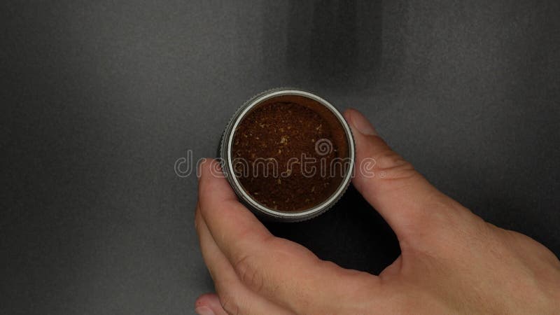 Top View of Hands Operating a Manual Coffee Grinder with Precision in a ...