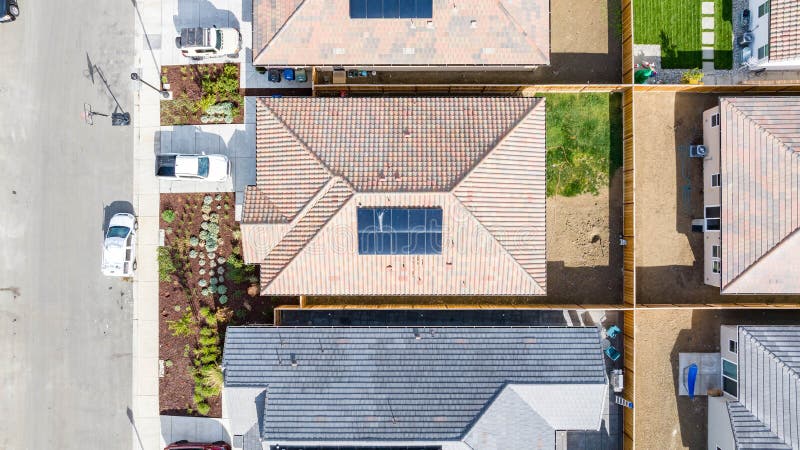 Top Down View of a House with a Solar Panel on it and a Empty Backyard ...