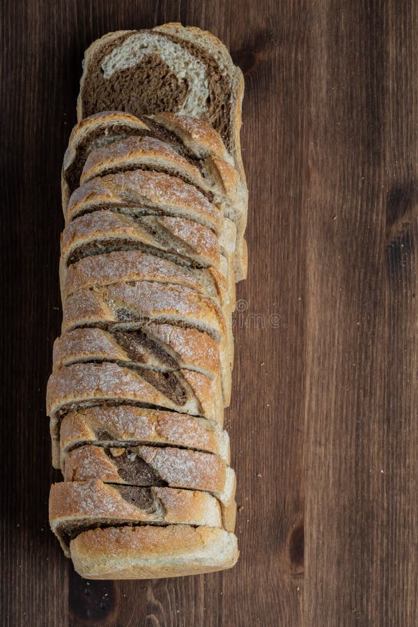 Top Down View of a Loaf of Marble Rye Bread Cut into Slices on a Wooden ...