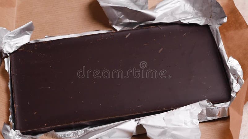 Top Down View on Open Chocolate Bar in Package. Dark Chocolate Revolves ...