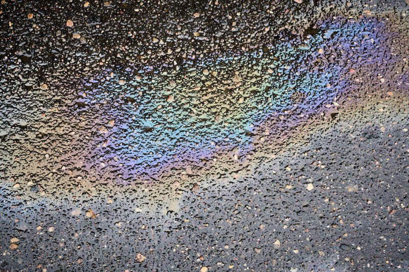 A Top-down View of a Reflective Puddle of Oil or Gasoline on Saturated ...