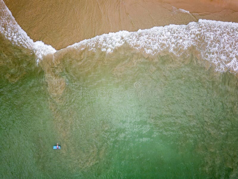 Top Down View of Surfers Waiting for Waves Off a Tropical Beach Stock ...
