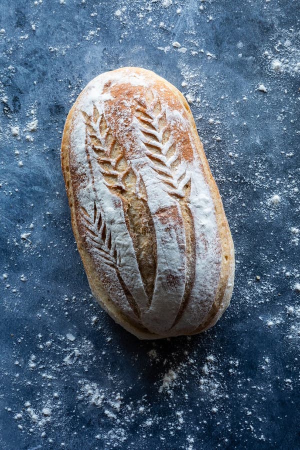 Top Down View of a Whole Loaf of Sourdough Bread on a Dark Wooden Table ...