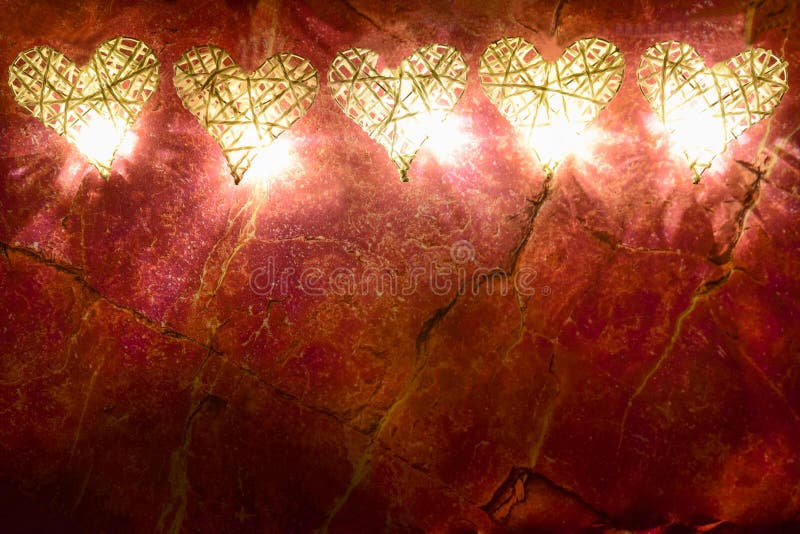 Five Handmade Wicker Decorative Hearts with Lights Set Against a Red ...