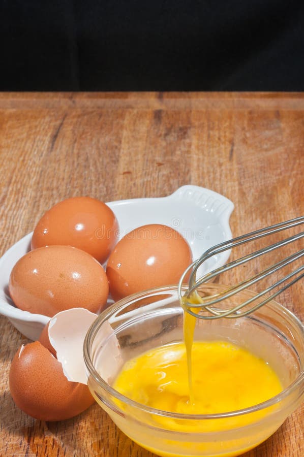 Glass Bowel of Egg with Chef`s Hand and Whisk, Egg Shell and Three ...