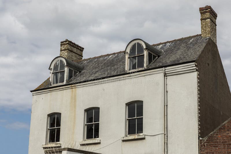 The Top Half of a White Building with Arched Attic Windows Stock Image ...