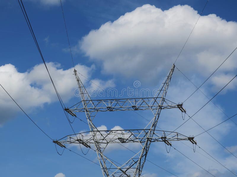 Top of a High-tension Tower with Lines Against Te Blue Sky Stock Photo ...