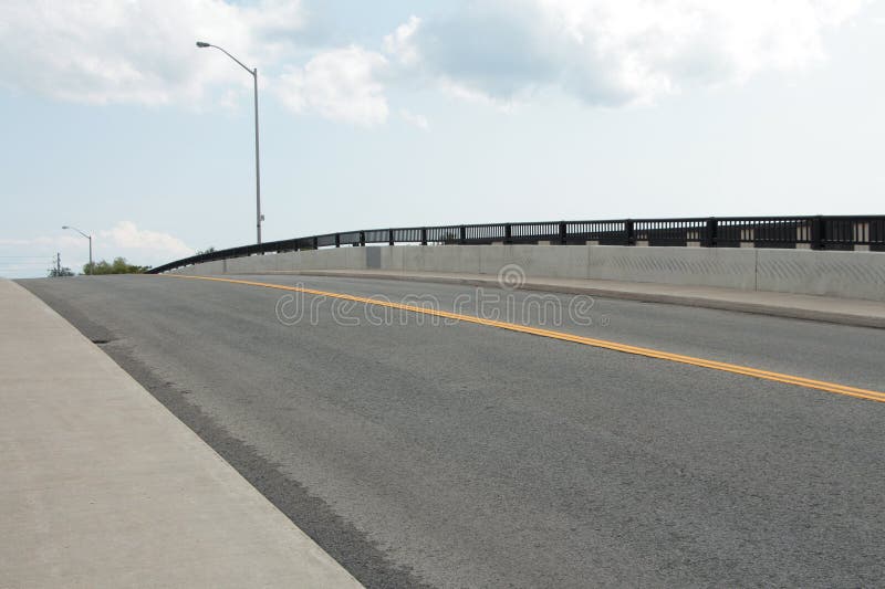 Top of Large Big Bridge Road with Sidewalk and Railing and Clouds Sky ...