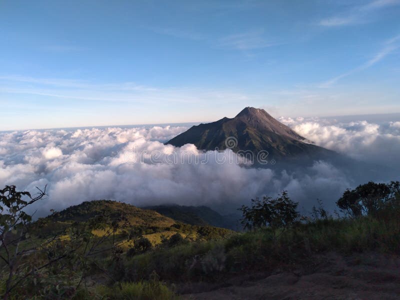 The Top of the Mountain Surrounded by White Clouds and Blue Sky in the ...