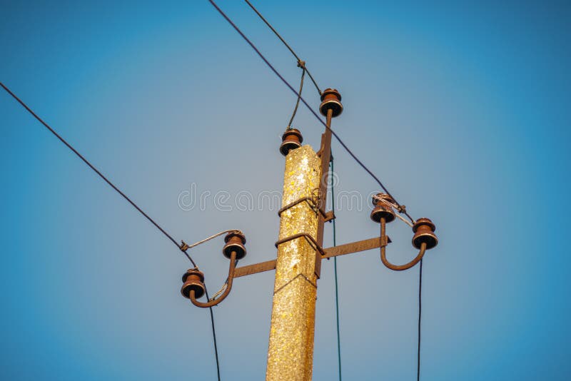 Top of an Old Electrical Pole with Plugs and Wires on a Blue Sky ...