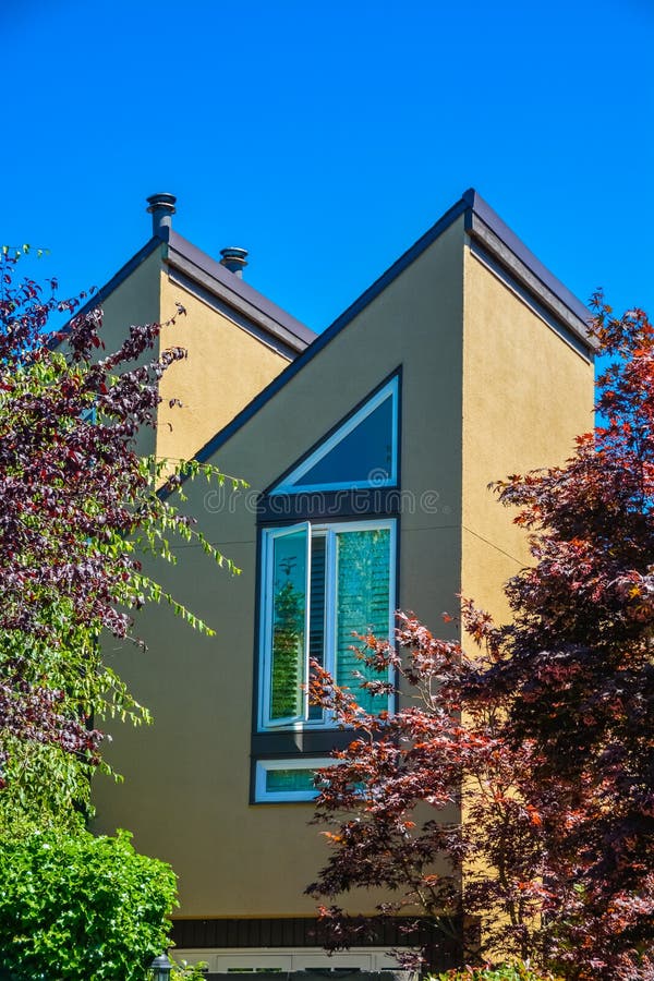 Top of Residential Building among the Trees with Triangle Shaped Window ...