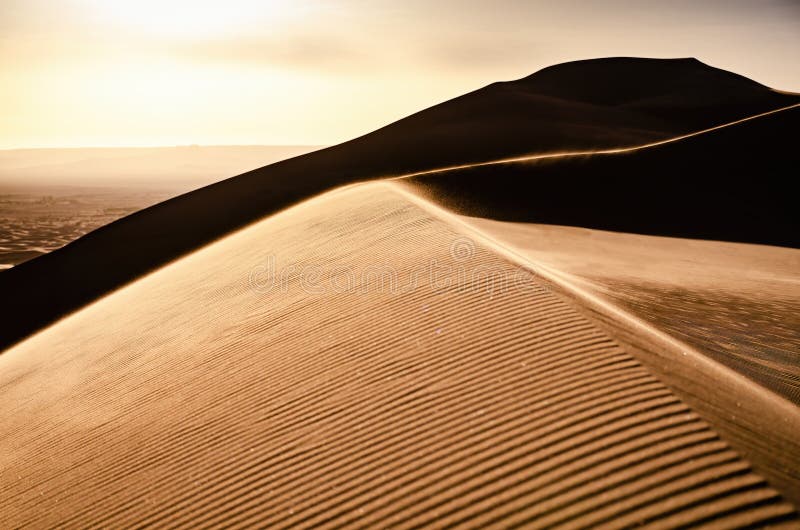 Top of a Sand Dune with Sand Dust Blowing Over the Top. Golden Desert ...