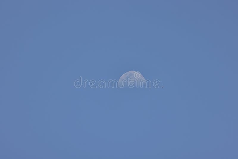 A Top Side of a Bright Half Moon Far Away in the Clear Blue Sk Stock ...