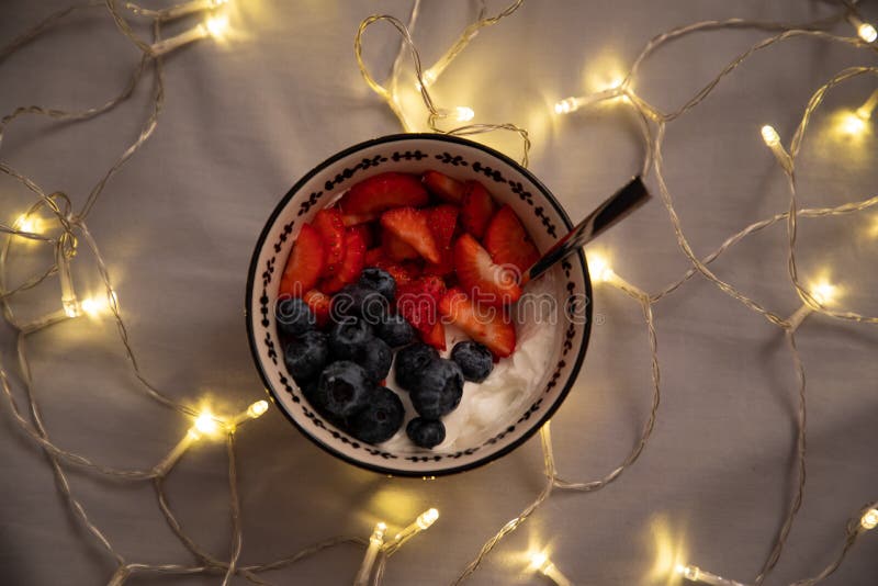 Top Side View of a Bowl with Yogurt, Strawberries and Blueberries Over ...