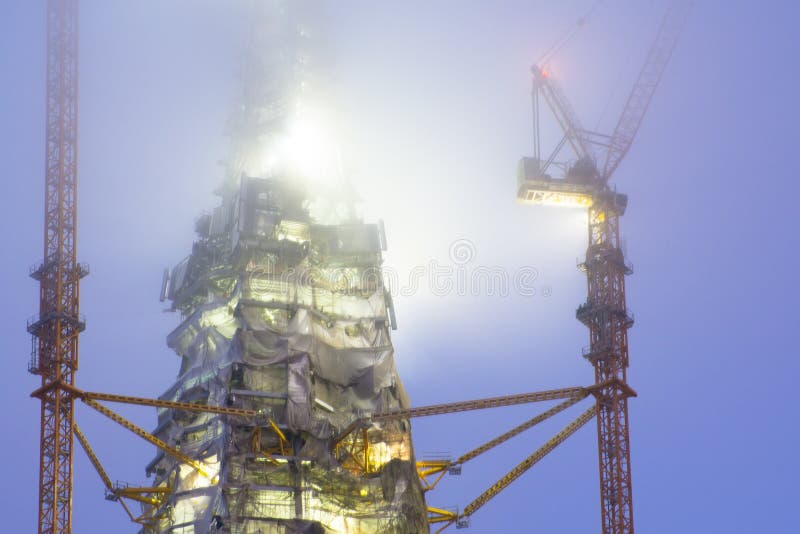 The Top of a Skyscraper during Construction with Building Cranes is ...