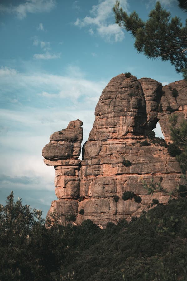 The Top of Three Large Rock Formations on a Hill with Trees Stock Image ...