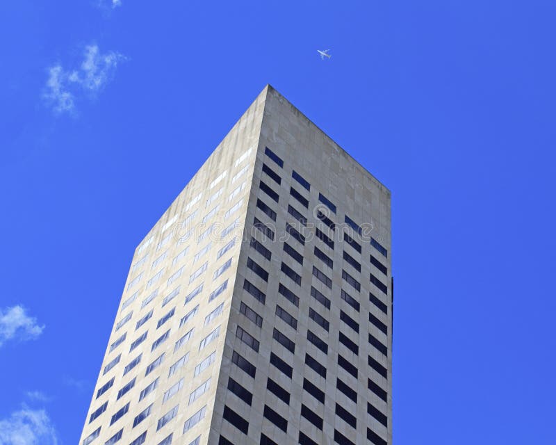 The Top of a Towering Skyscraper in Front of Blue Sky Stock Photo ...