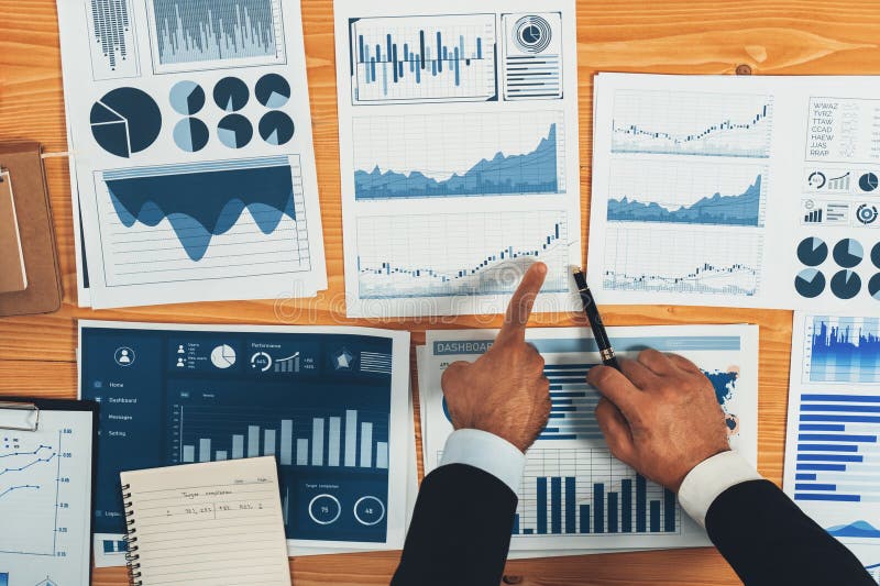 Top View Analyst Team Working on Dashboard Paper on Table. Fervent ...