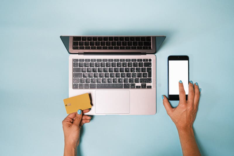 Anonymous Using Smartphone while Browsing Laptop and Shopping with Card ...