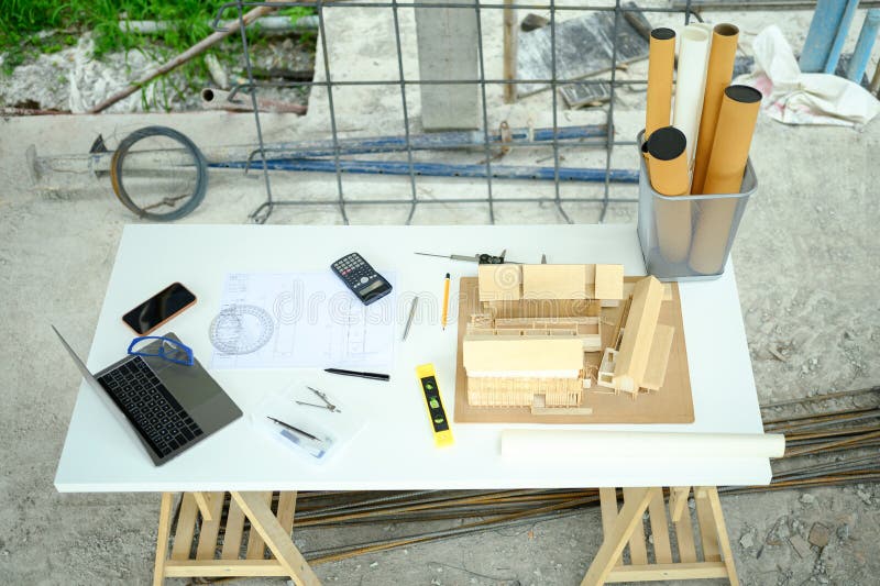 Top View Architectural House Model, Laptop and Blueprints on Table at ...
