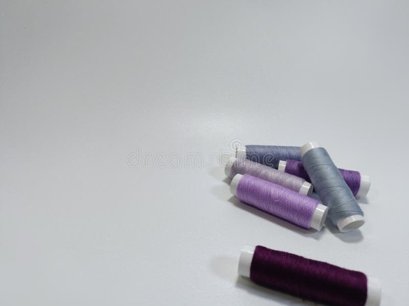 Top View of Assorted Purple and Gray Sewing Thread Spools on White ...