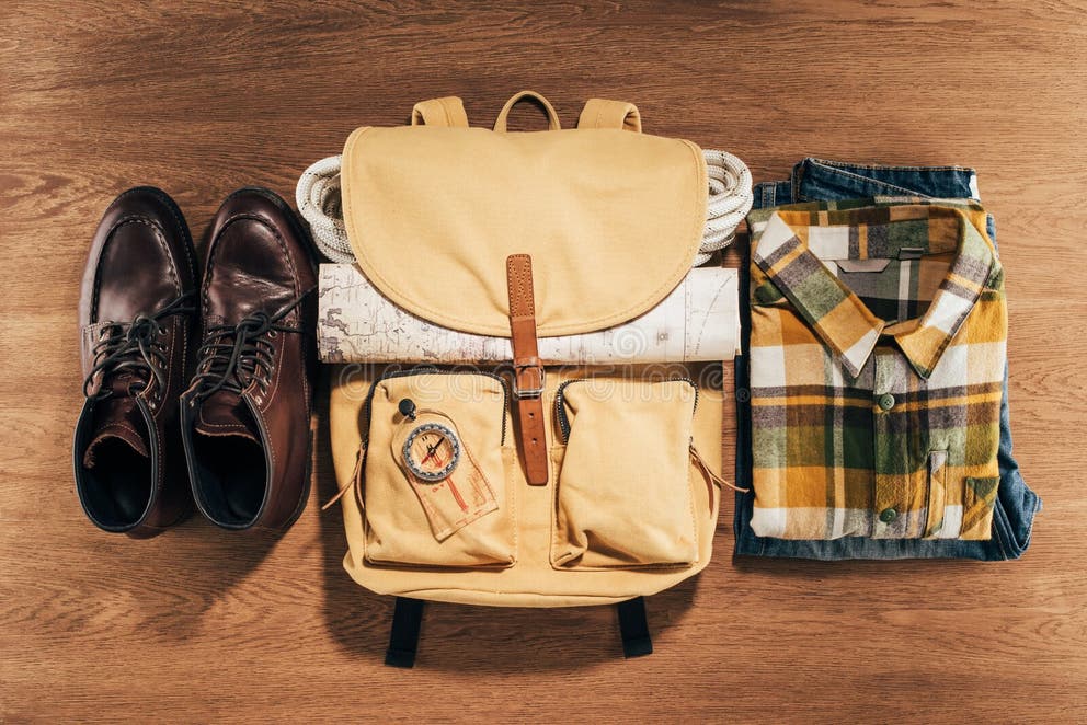Top View of Backpack with Compass Map and Clothes Stock Photo - Image ...