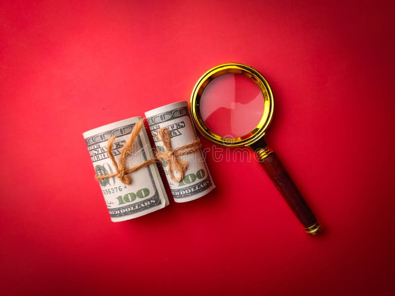 Top View Banknotes and Vintage Magnifying Glass on a Red Background ...