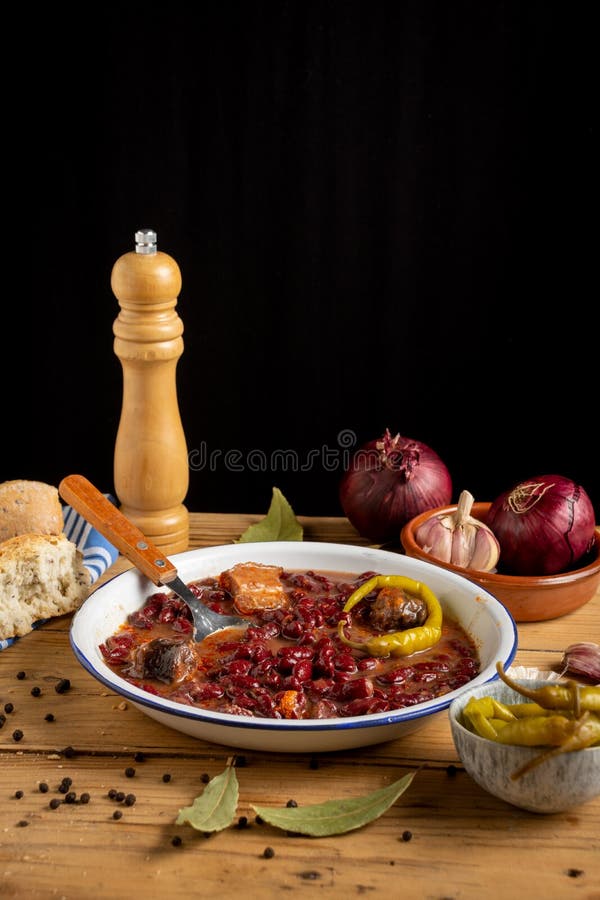 Top View of Basque Bean Stew with Spoon on Rustic Table with Onions ...